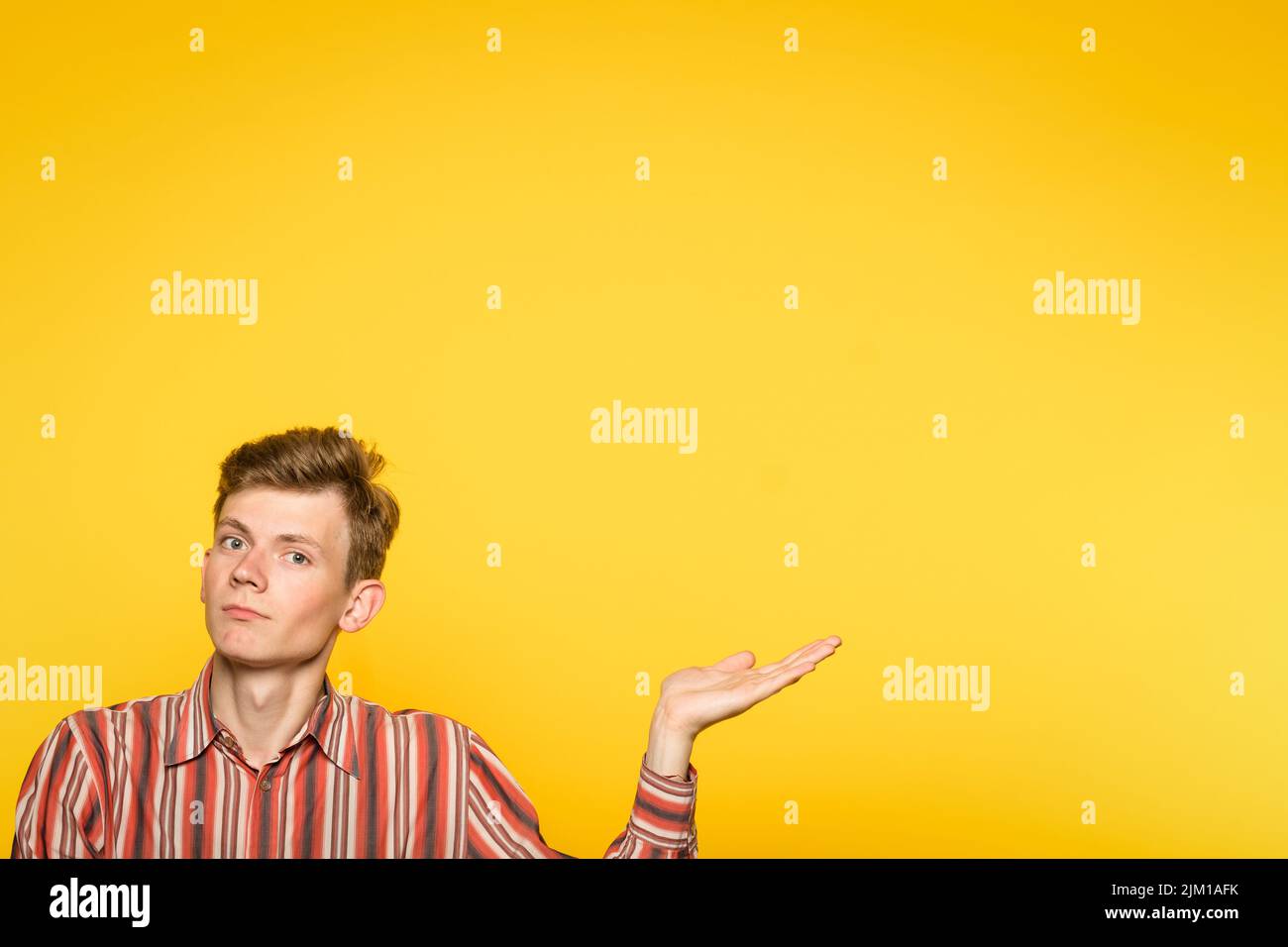 handsome young man pointing sideways hand showing Stock Photo - Alamy