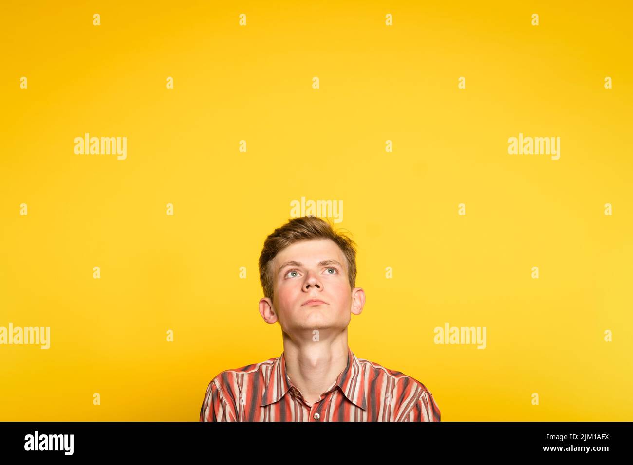 serious concentrated handsome man looking up Stock Photo - Alamy