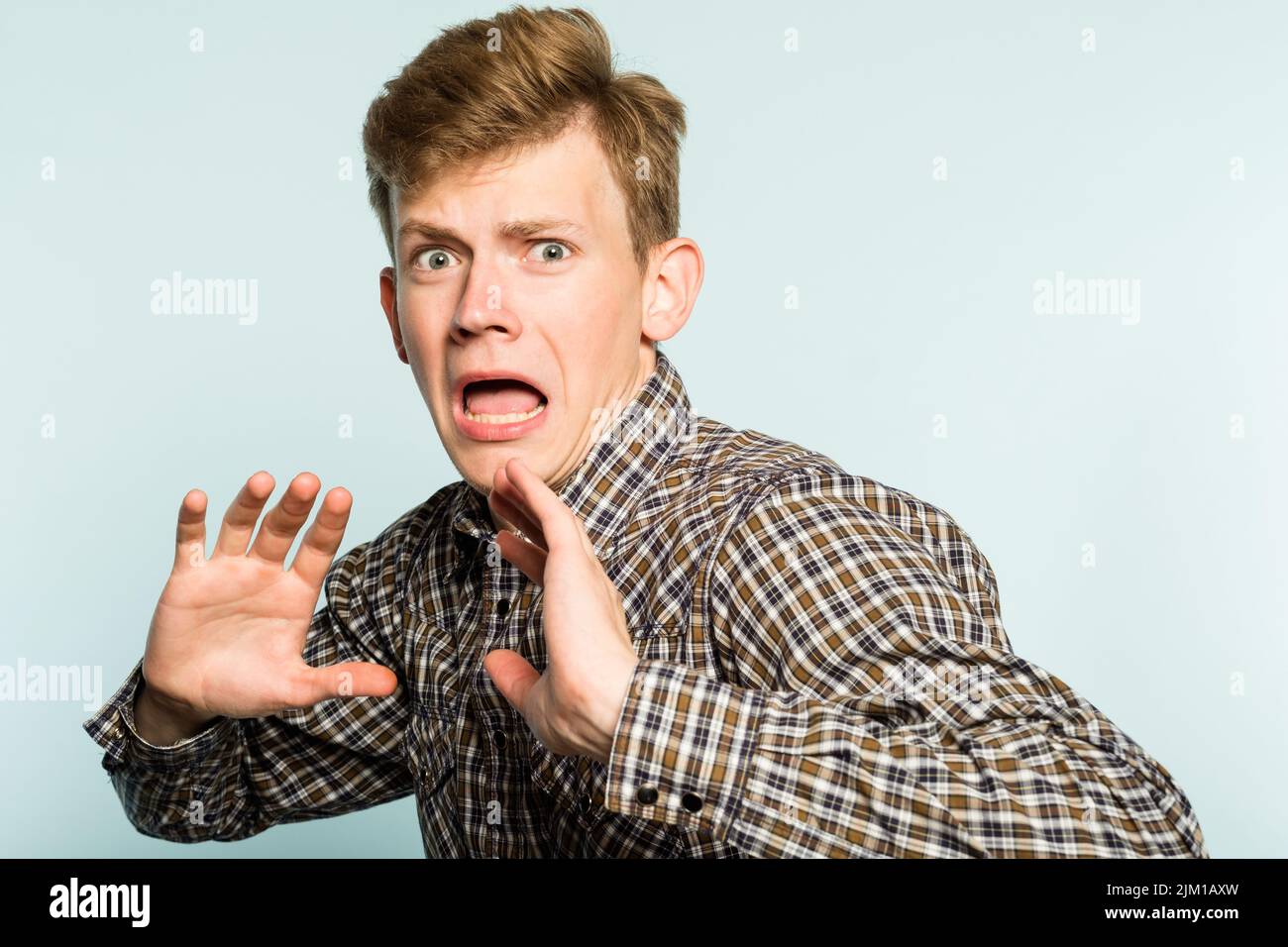scared frightened man cowardly comical reaction Stock Photo - Alamy