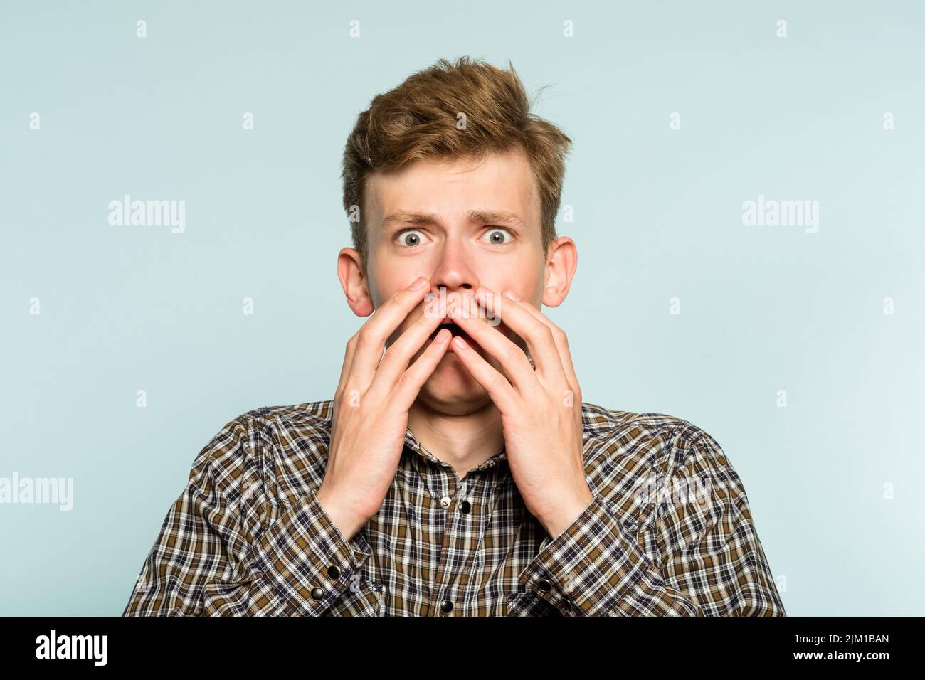 scared shocked terrified startled man hand emotion Stock Photo - Alamy