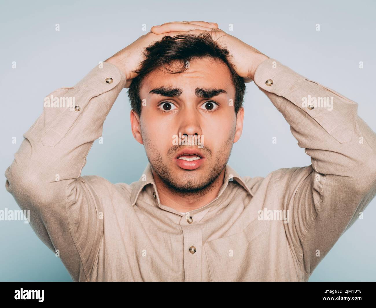 terrified shocked alarmed man clutch head emotion Stock Photo - Alamy