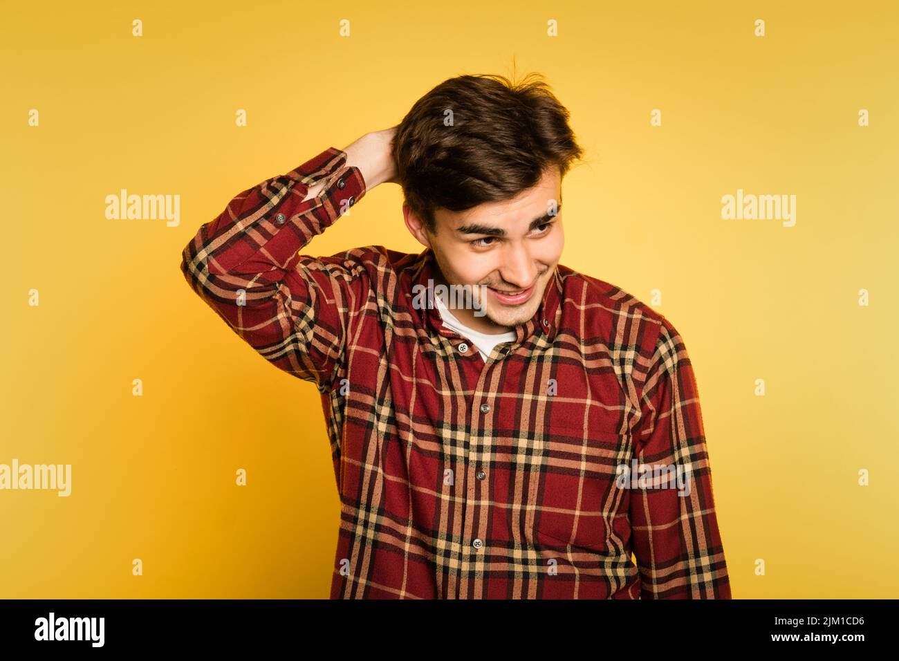 relaxed laid back man scratch head smiling emotion Stock Photo - Alamy
