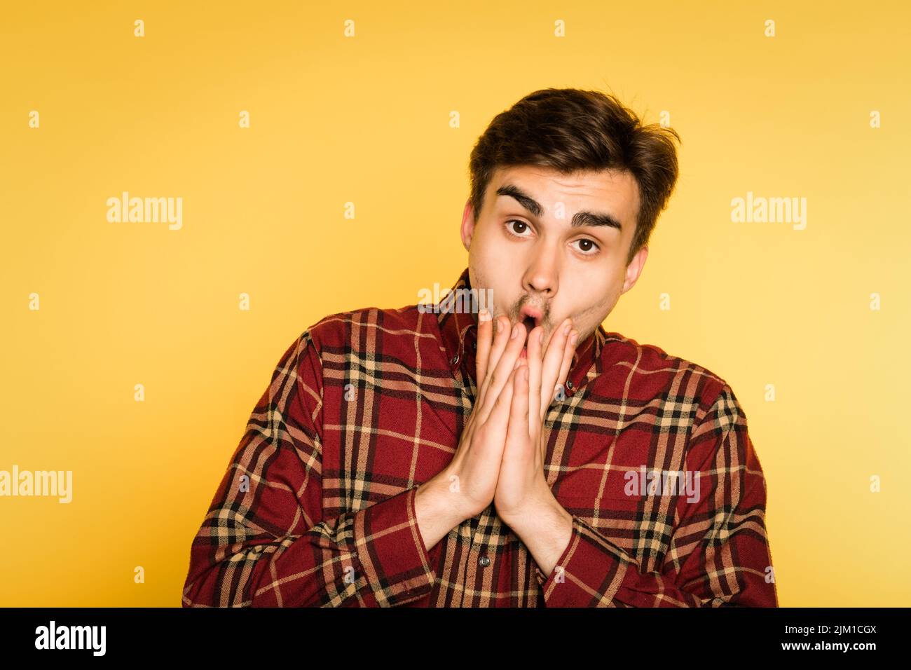 Young man covering mouth hands hi-res stock photography and images - Alamy