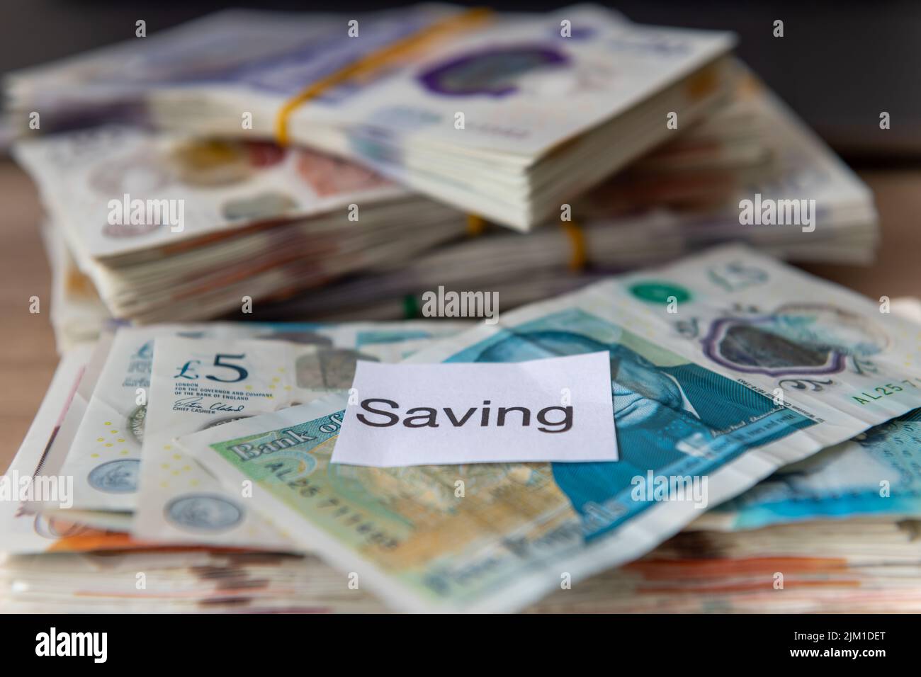 A pile bank notes with the word saving. Saving money, wealth concept ...