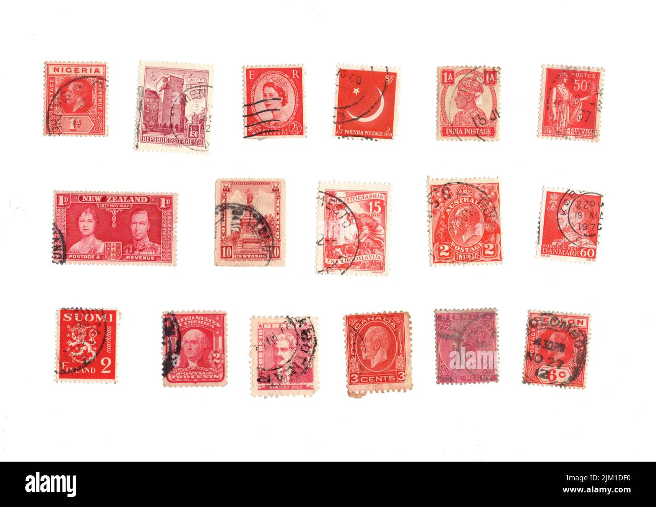A selection of old red postage stamps from around the world on a white ...