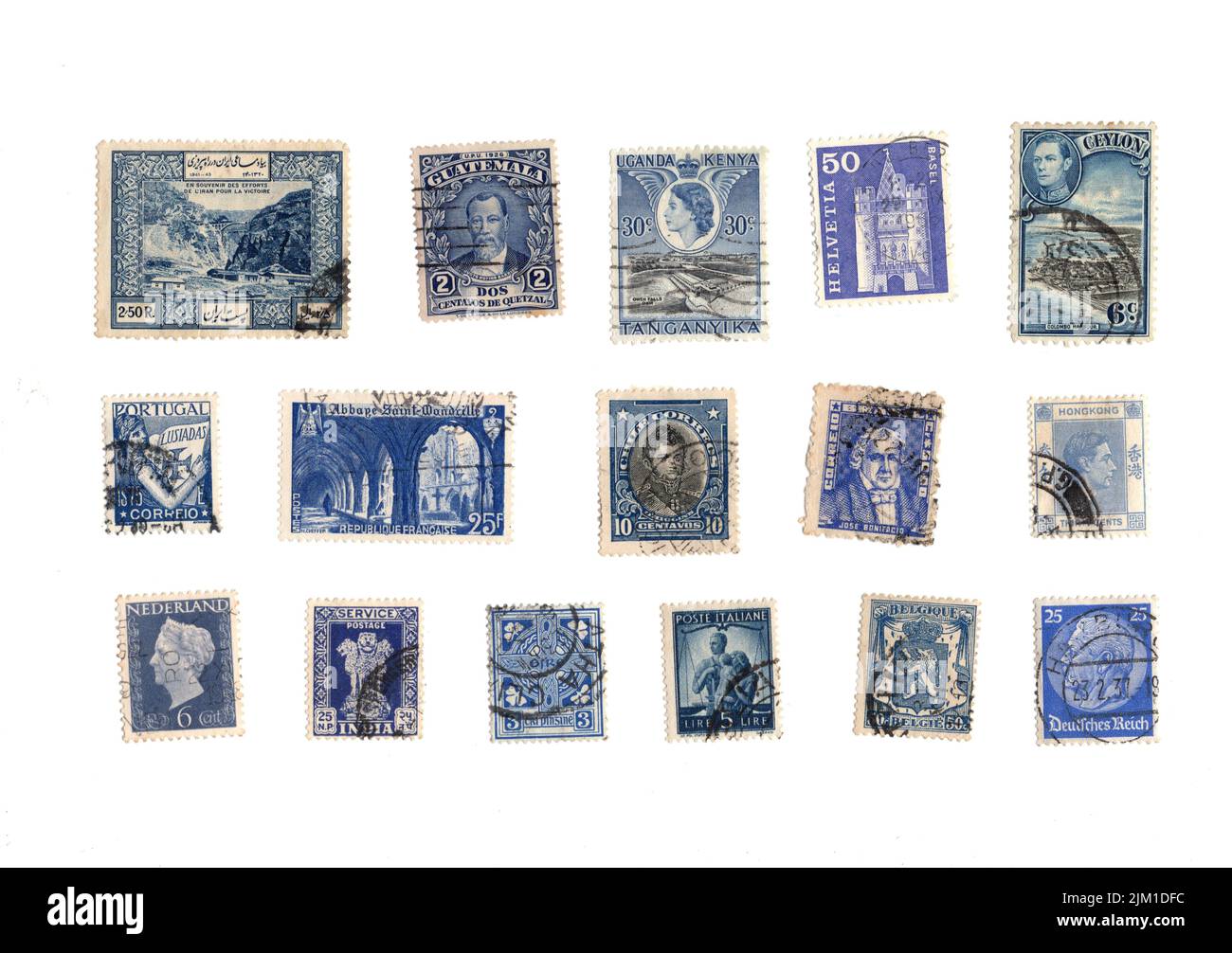 A selection of old blue postage stamps from around the world on a white ...