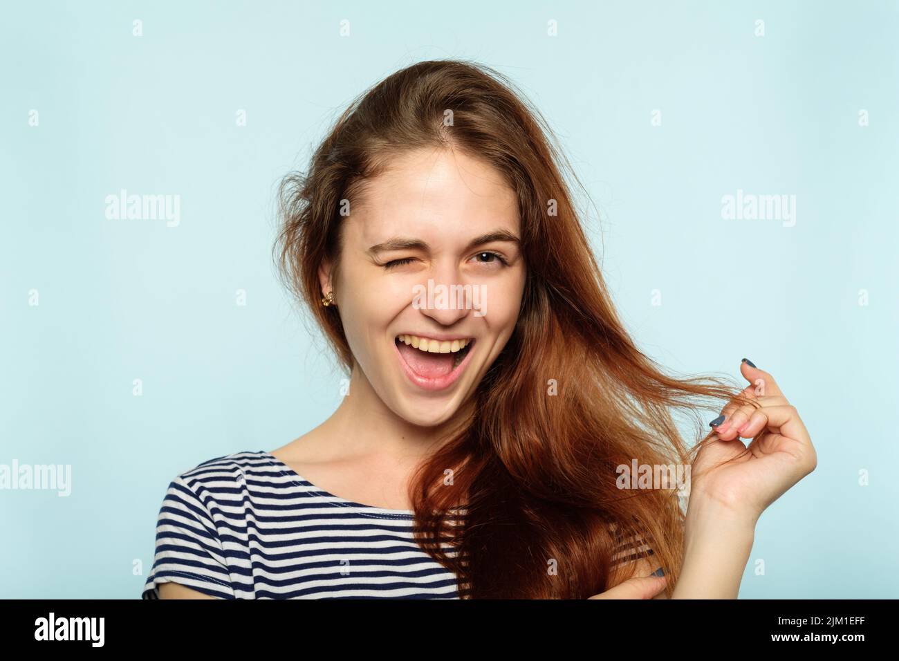 emotion face smiling woman pleased winking Stock Photo - Alamy