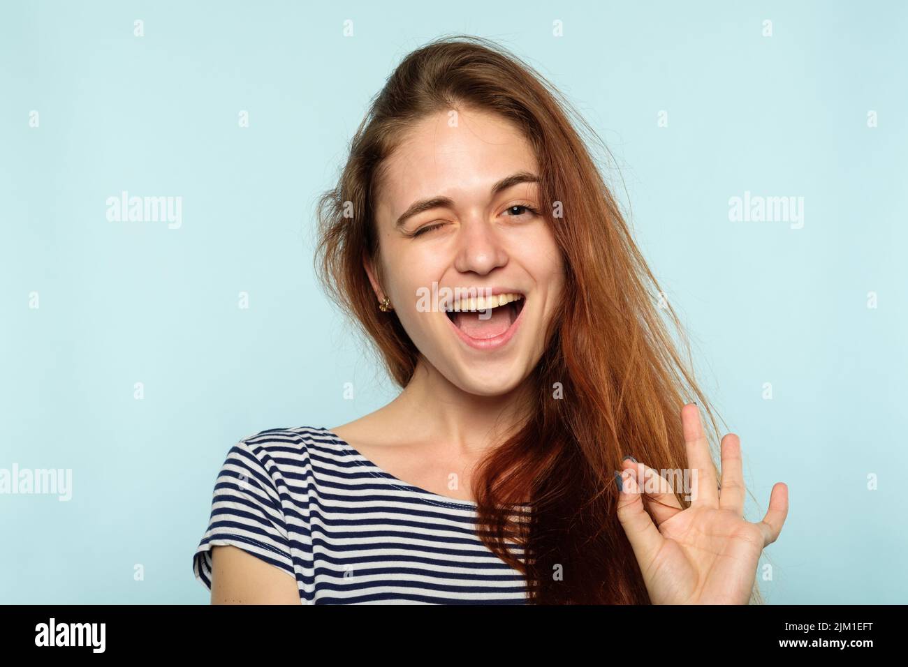 ok winking expression happy smiling joyful girl Stock Photo - Alamy ok winking expression happy smiling joyful girl Stock Photo - Alamy