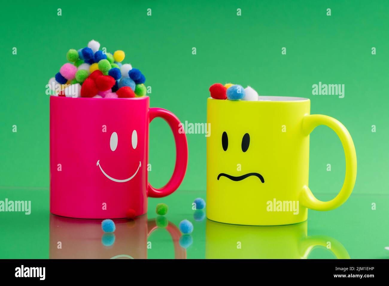Two mugs with happy and sad emotions on the background. Concept, Coffee ...