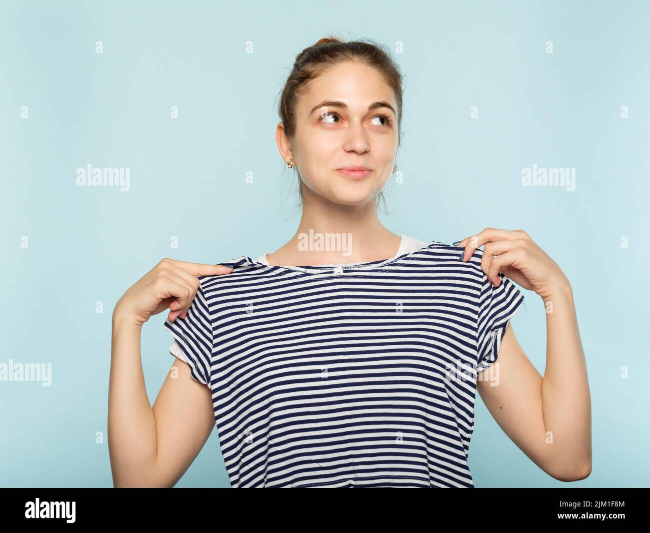 shopping fashion clothes fitting girl trying shirt Stock Photo - Alamy