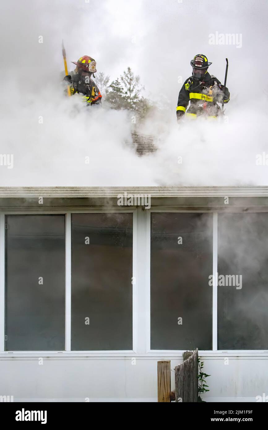 Firefighters prepare to open up the roof as the East Hampton Fire ...