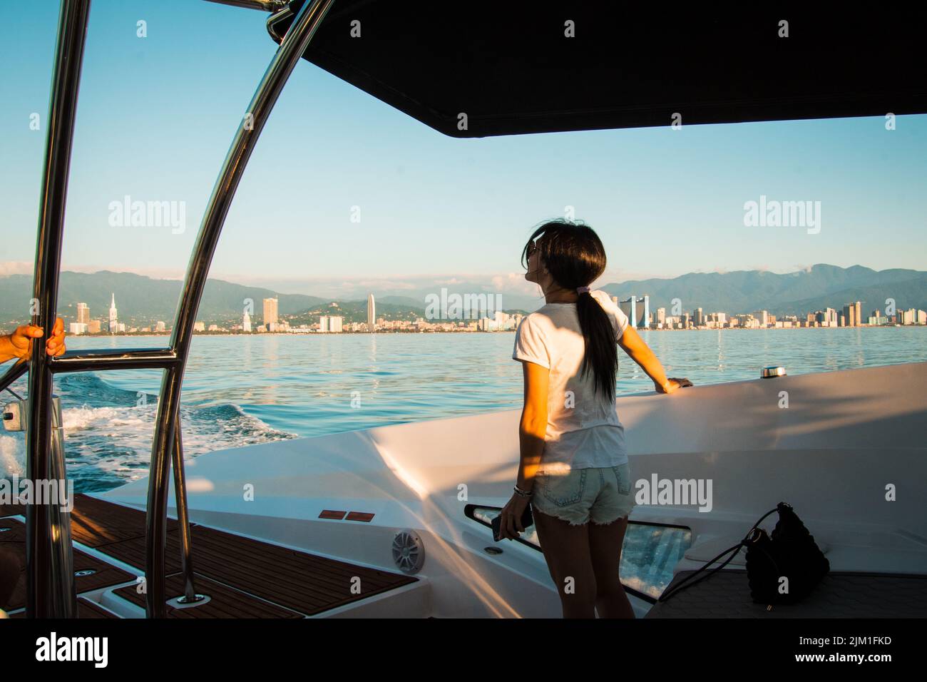 Tourist Woman on boat tour enjoy summer sunset in Georgia resort ...