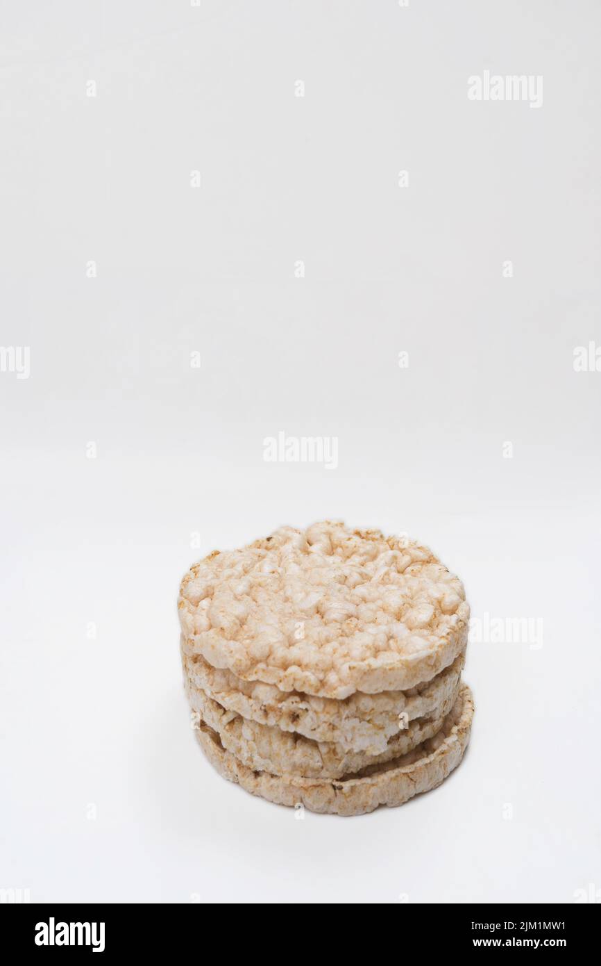 Exquisite round rice crackers on a white surface. Copy Space. Healthy ...