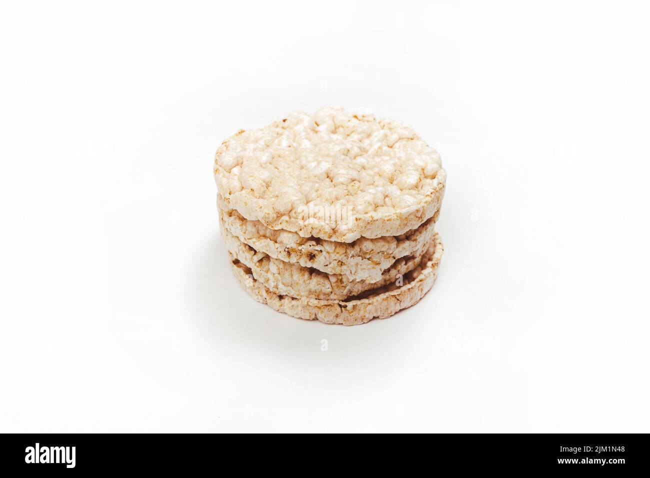 Exquisite stack of round rice crackers on a white surface. Copy Space ...