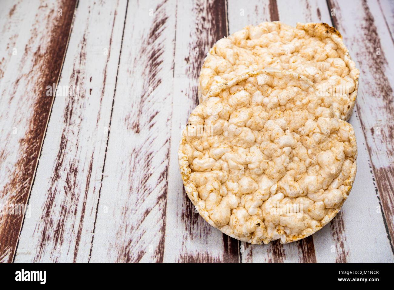 A Round rice crackers on a rustic wooden table. Copy space. Healthy ...