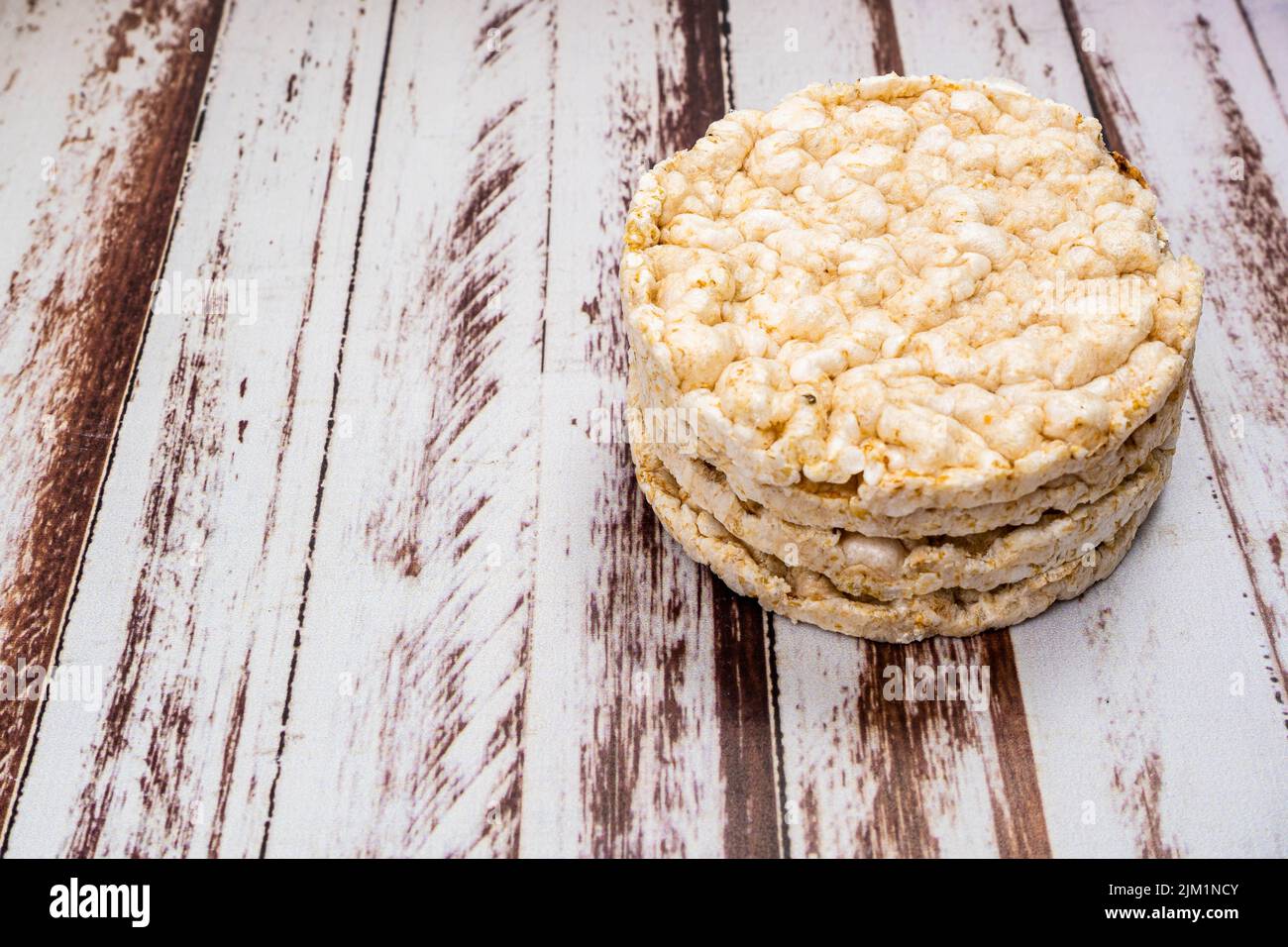 A Round rice crackers on a rustic wooden table. Copy space. Healthy ...