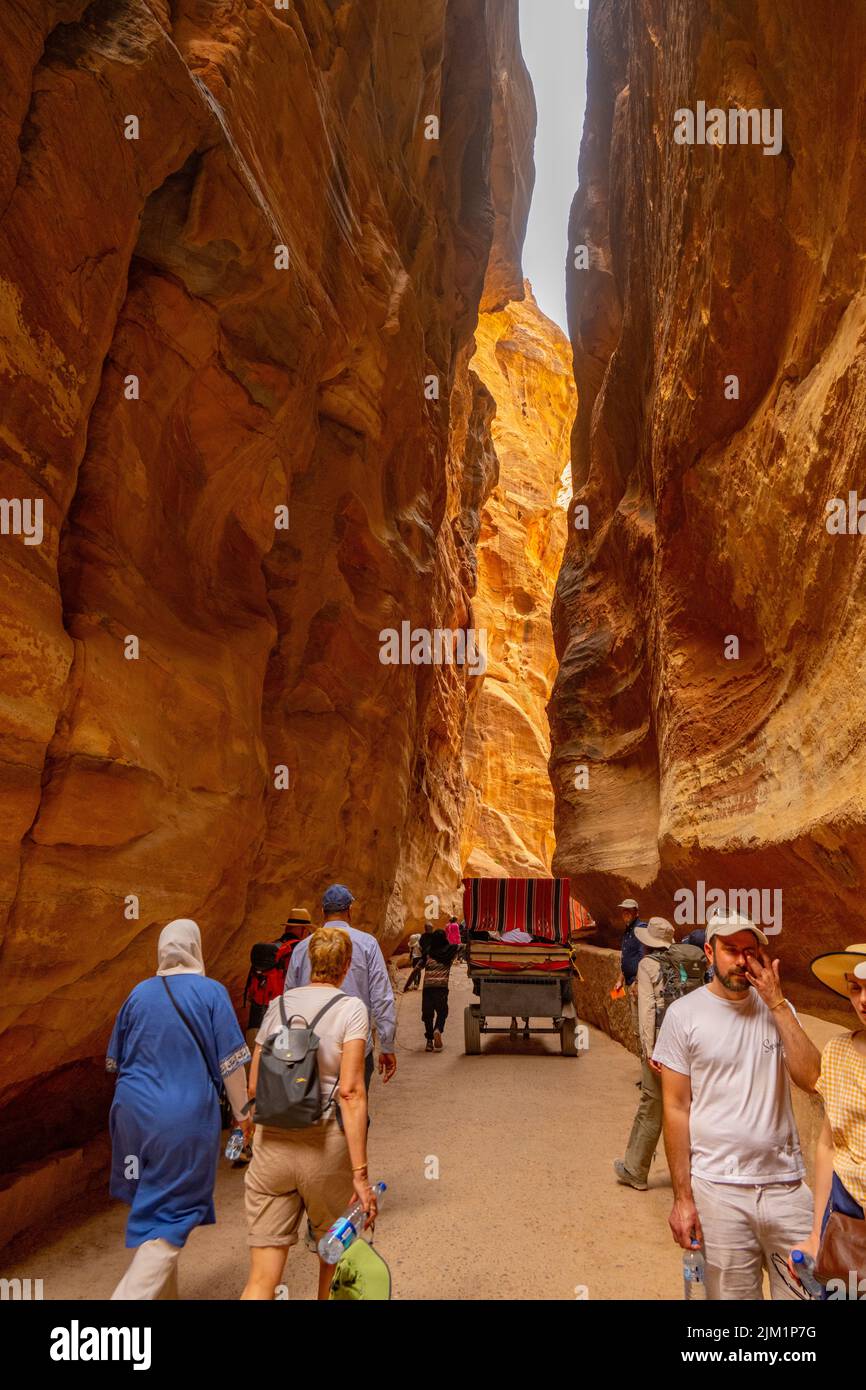 Crowds walking up Al-Siq canyon. From the entrance to Petra Jordan ...