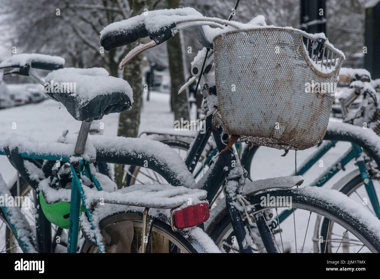Bikes covered in snow Stock Photo - Alamy