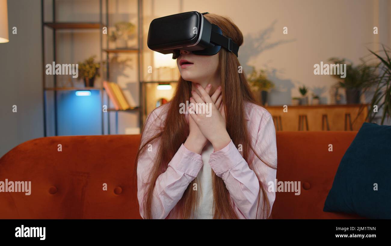 Young teen child girl using virtual reality futuristic technology VR ...