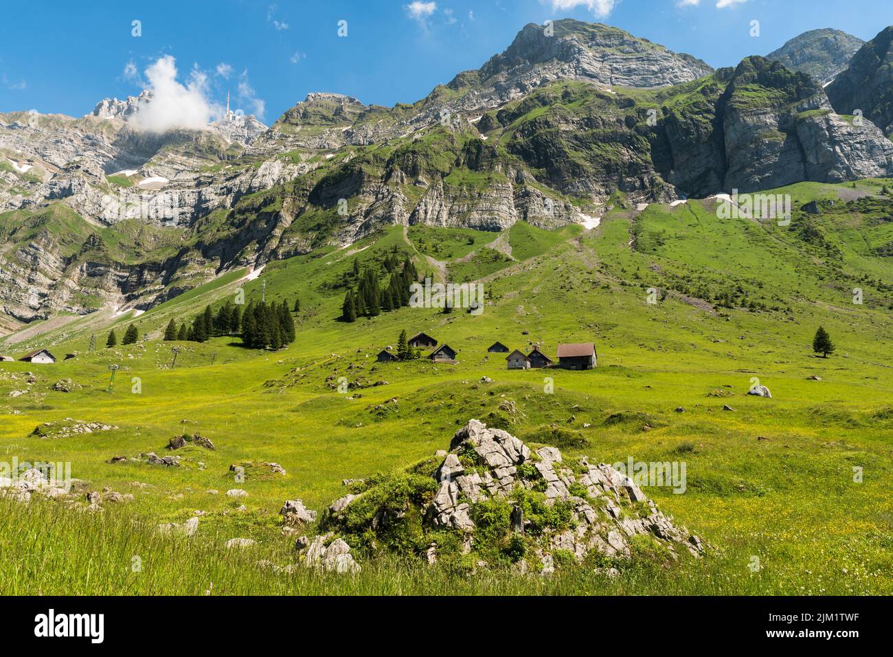 Mountain huts and pastures in the Swiss Alps with view of Mount Saentis ...