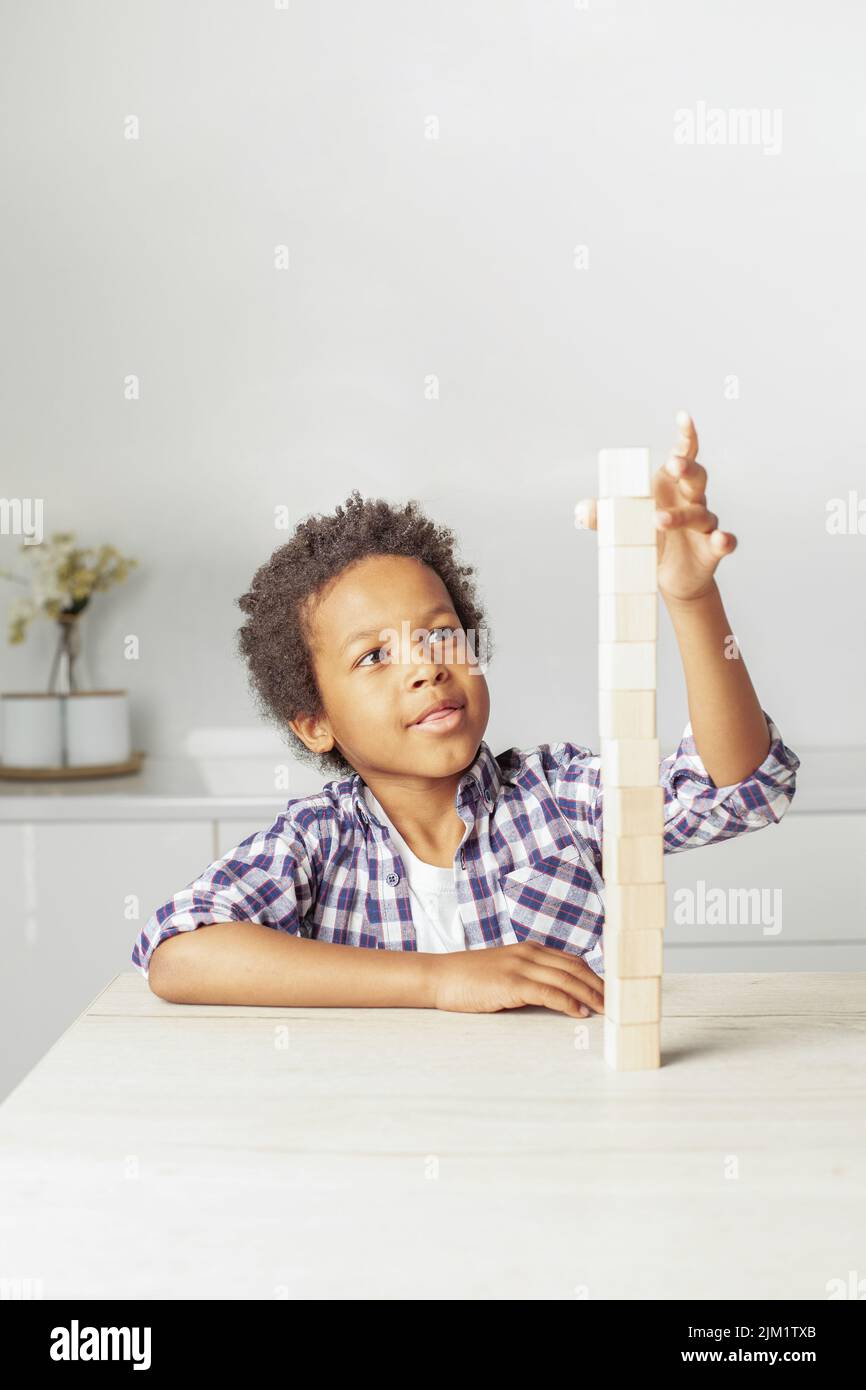 Creative kid building a block tower at home Stock Photo - Alamy