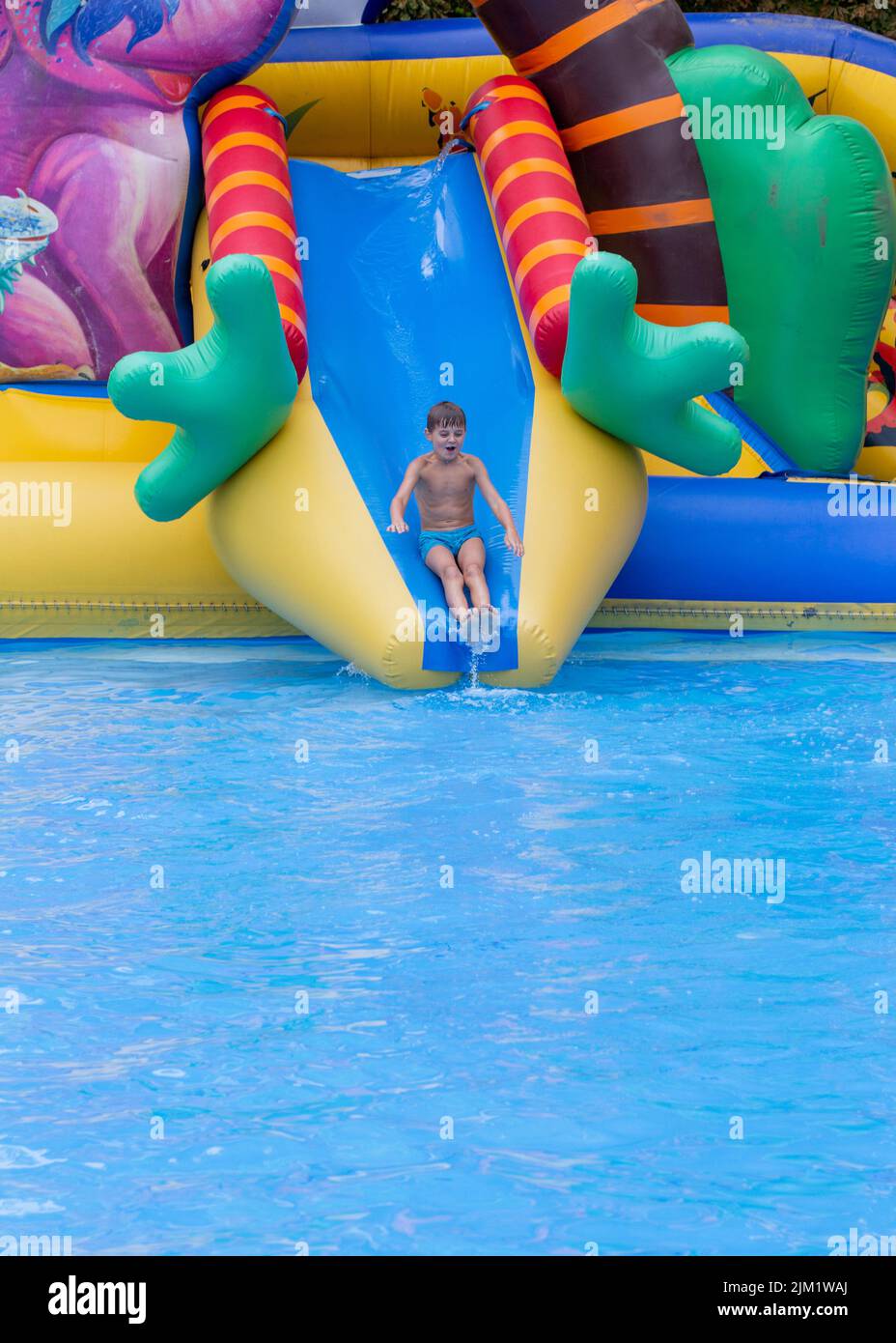 Happy boy going down slide hi-res stock photography and images - Alamy