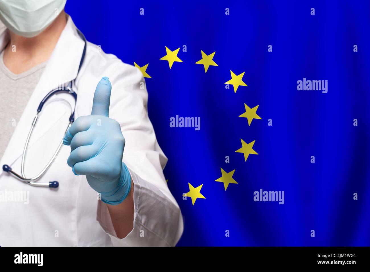 EU doctor's hand showing thumb up positive gesture on flag of European ...