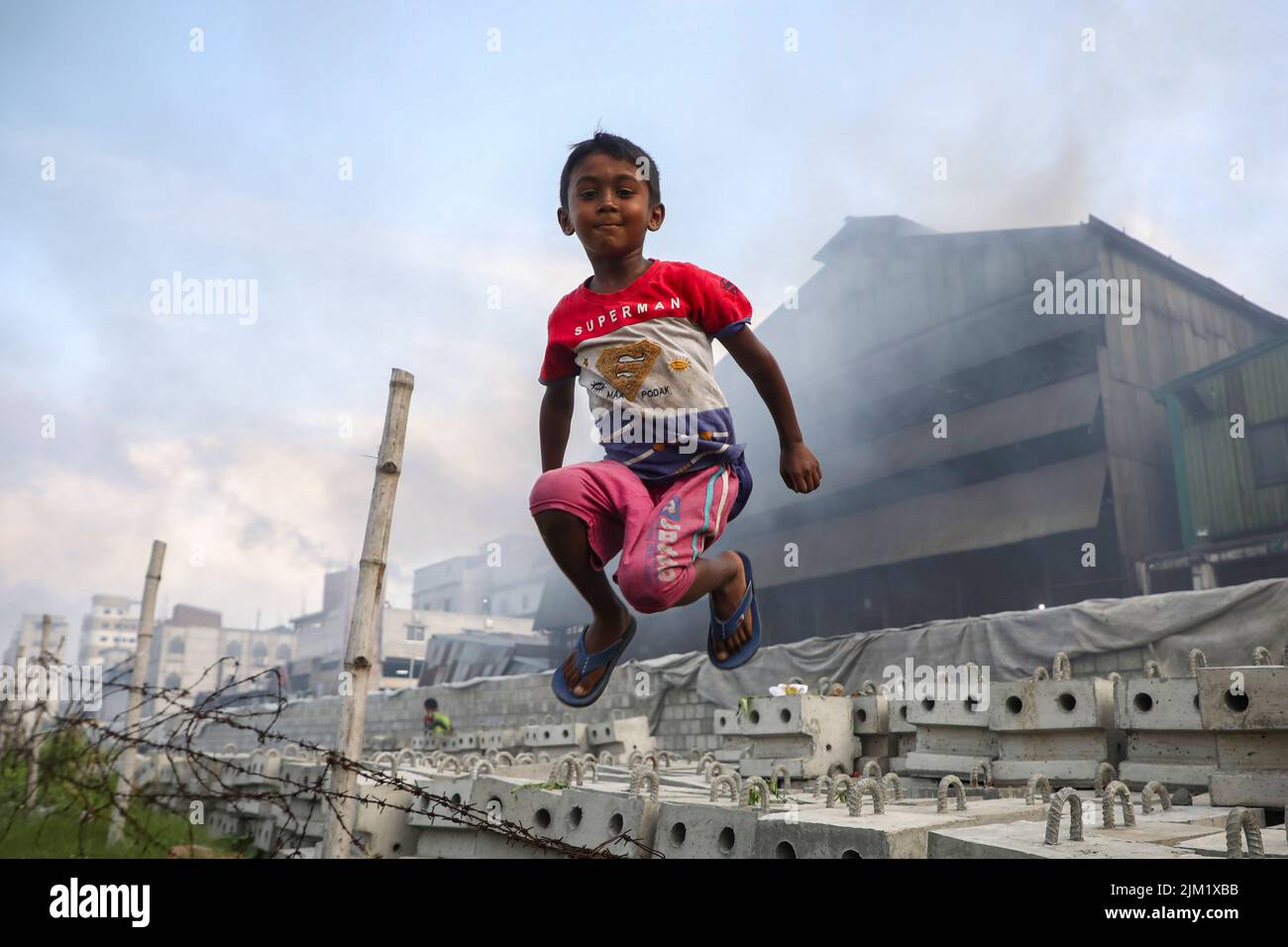 Dhaka, Bangladesh. 03rd Aug, 2022. A child is seen playing amid an air ...