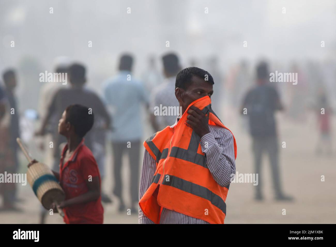 Dhaka, Bangladesh. 03rd Aug, 2022. A worker covers his nose with his ...