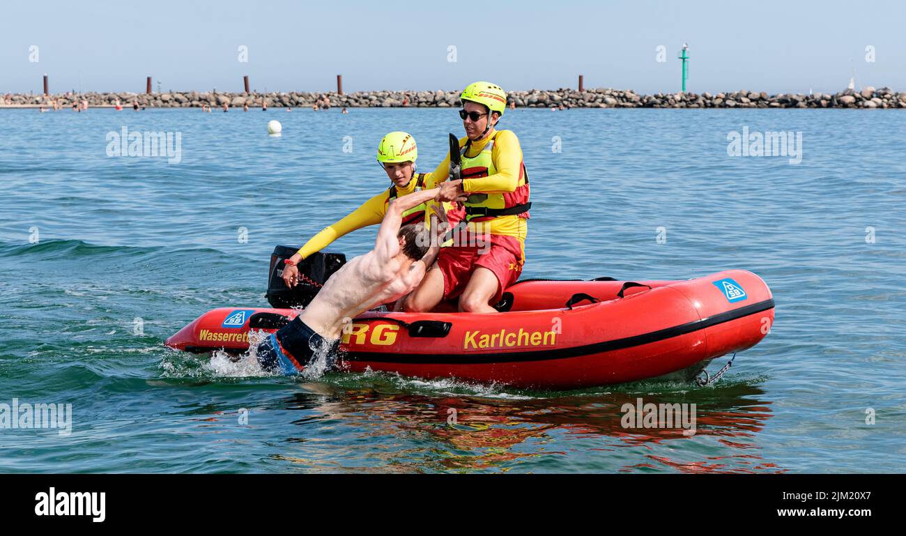 Damp, Germany. 04th Aug, 2022. DLRG lifeguards pull an extra on board ...