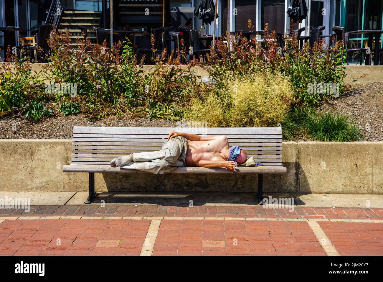 Baltimore, MD, USA – August 2, 2022: A homeless person sleeps on a ...