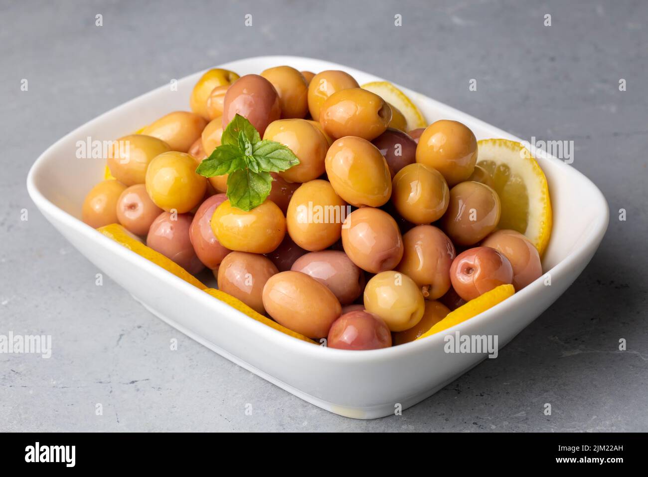 Scratched green olives. Tasty organic green olives in the plate. Olive ...
