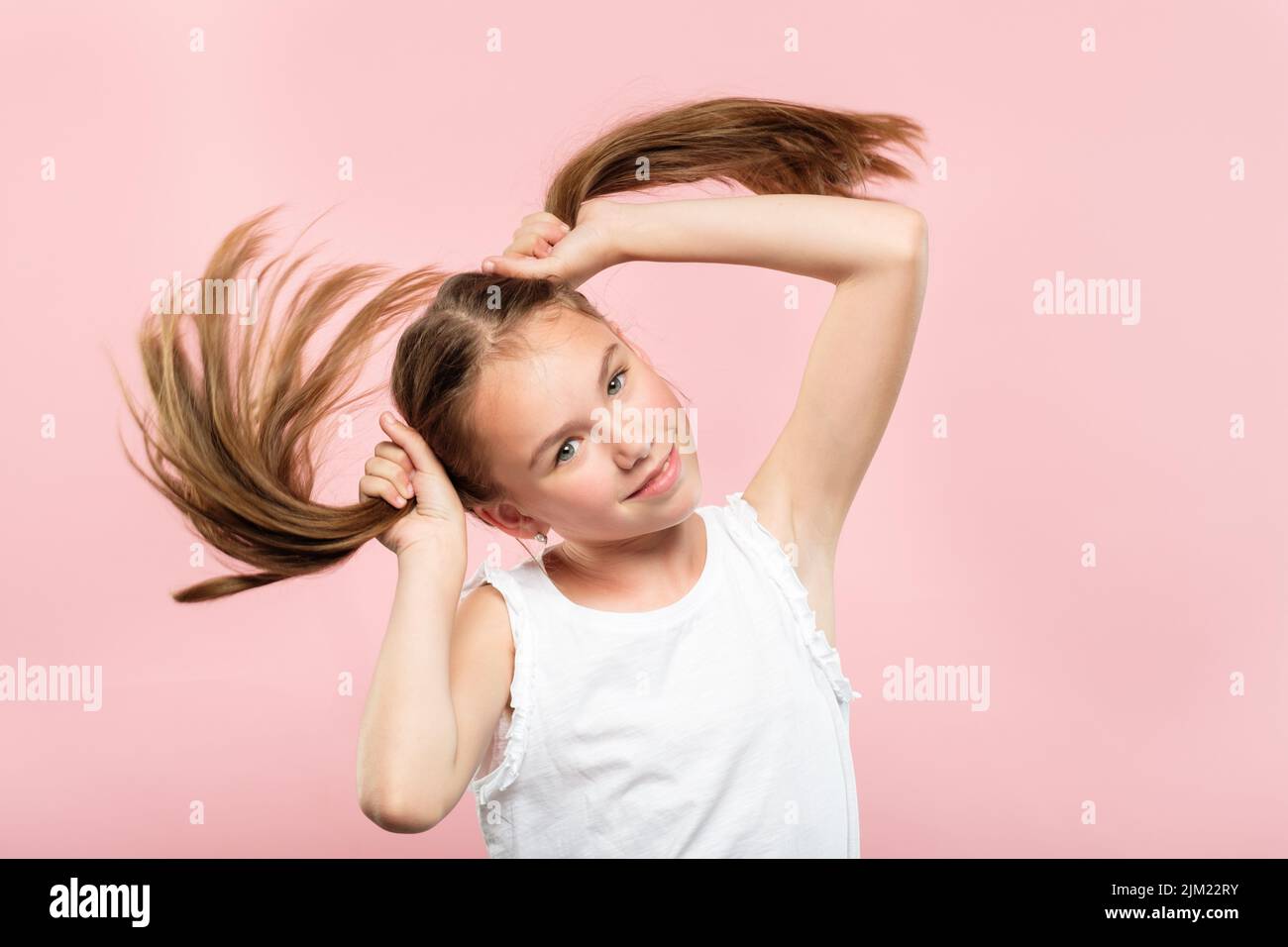 smiling adolescent girl pig tails hair carefree Stock Photo - Alamy
