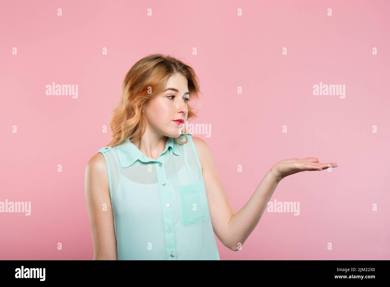 blond girl look holding virtual object empty hand Stock Photo - Alamy
