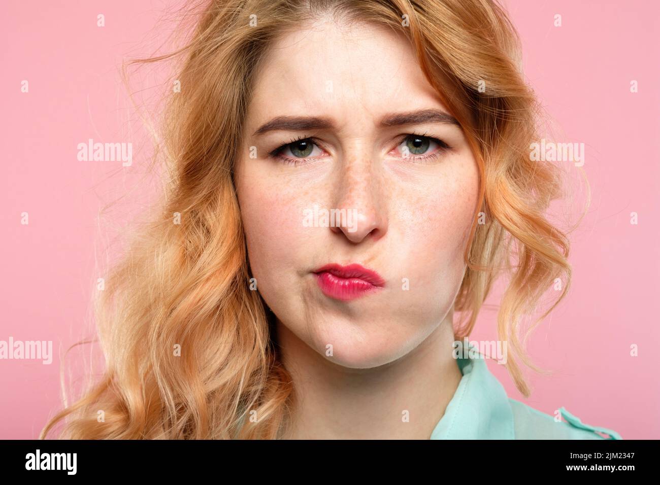 facial expression quizzical grumpy thoughtful girl Stock Photo - Alamy