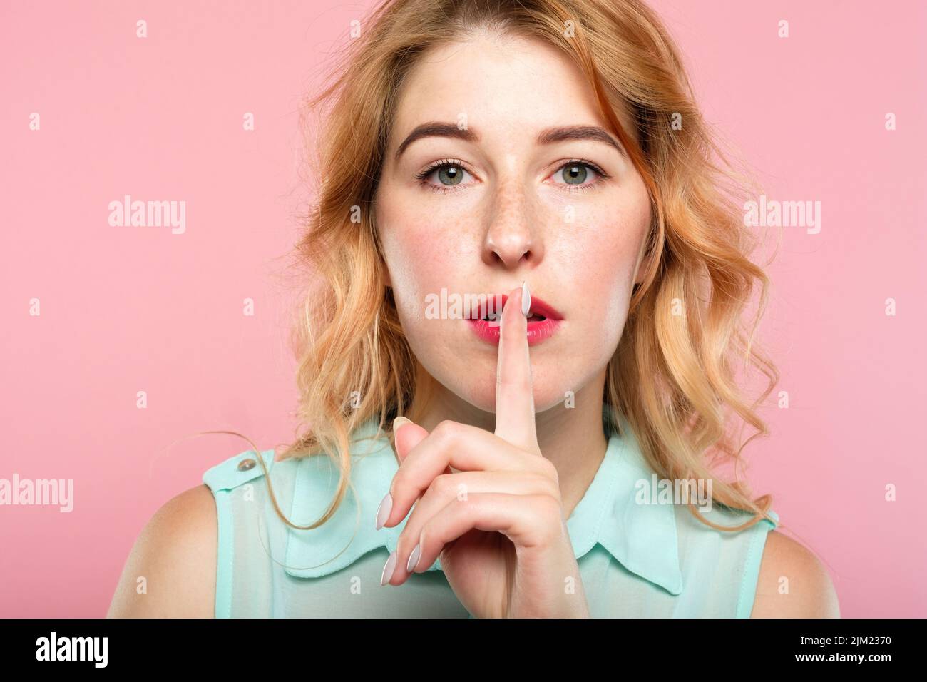 quiet silence shush girl portrait finger on lips Stock Photo - Alamy