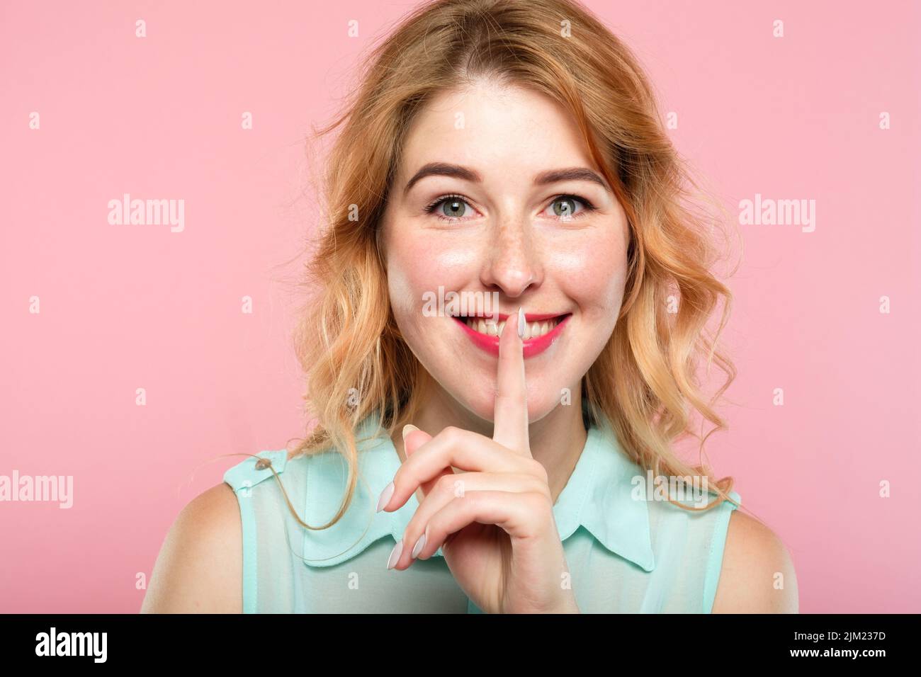 female secret mystery girl finger on lips gesture Stock Photo - Alamy