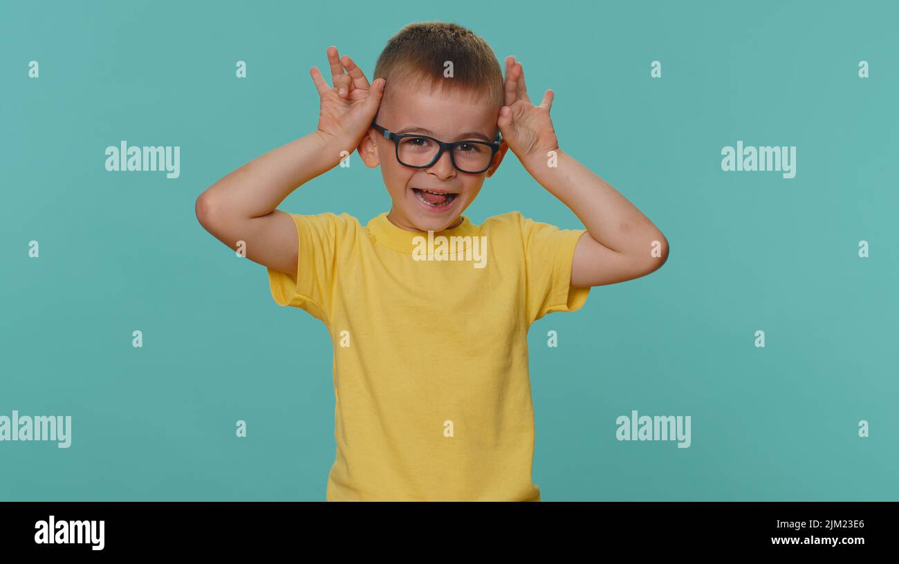 Funny little toddler children boy in yellow t-shirt making playful ...