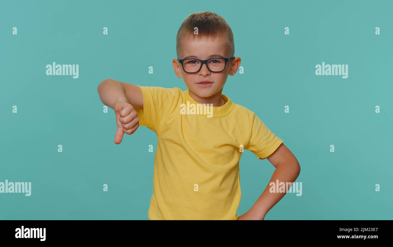Dislike. Upset little toddler children boy showing thumbs down sign ...
