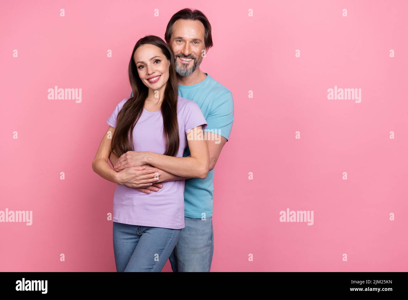 Photo of two lovely peaceful people hug have good mood look camera ...