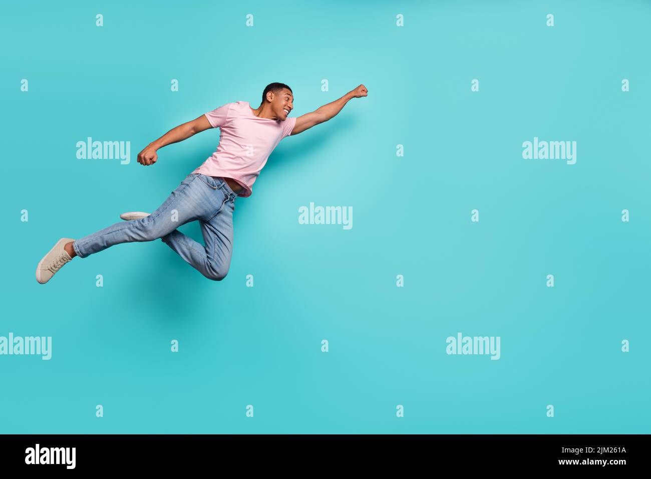 Full length photo of strong hurrying guy wear pink t-shirt jumping high ...