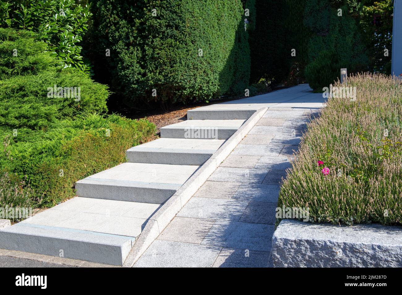 Neat and tidy front yard with solid block steps Stock Photo - Alamy