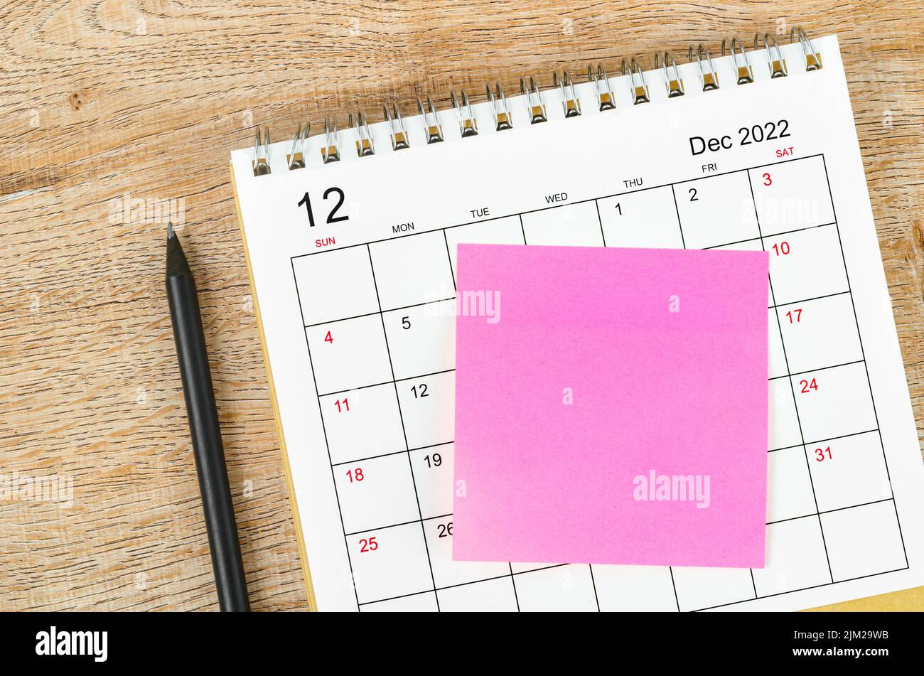 Blank sticky note on December 2022 desk calendar on wooden background ...