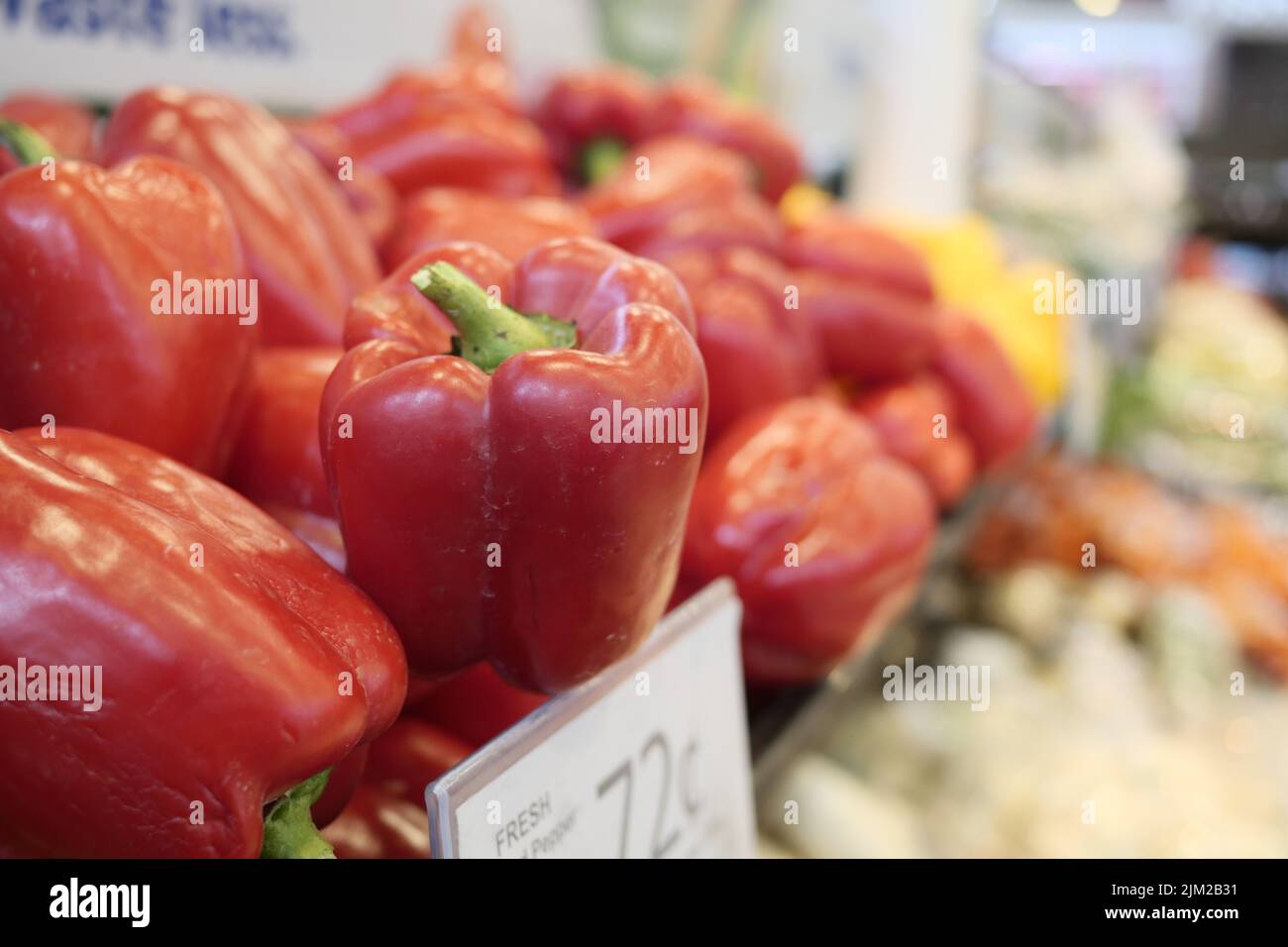 red color capsicum display for sale at local store Stock Photo - Alamy