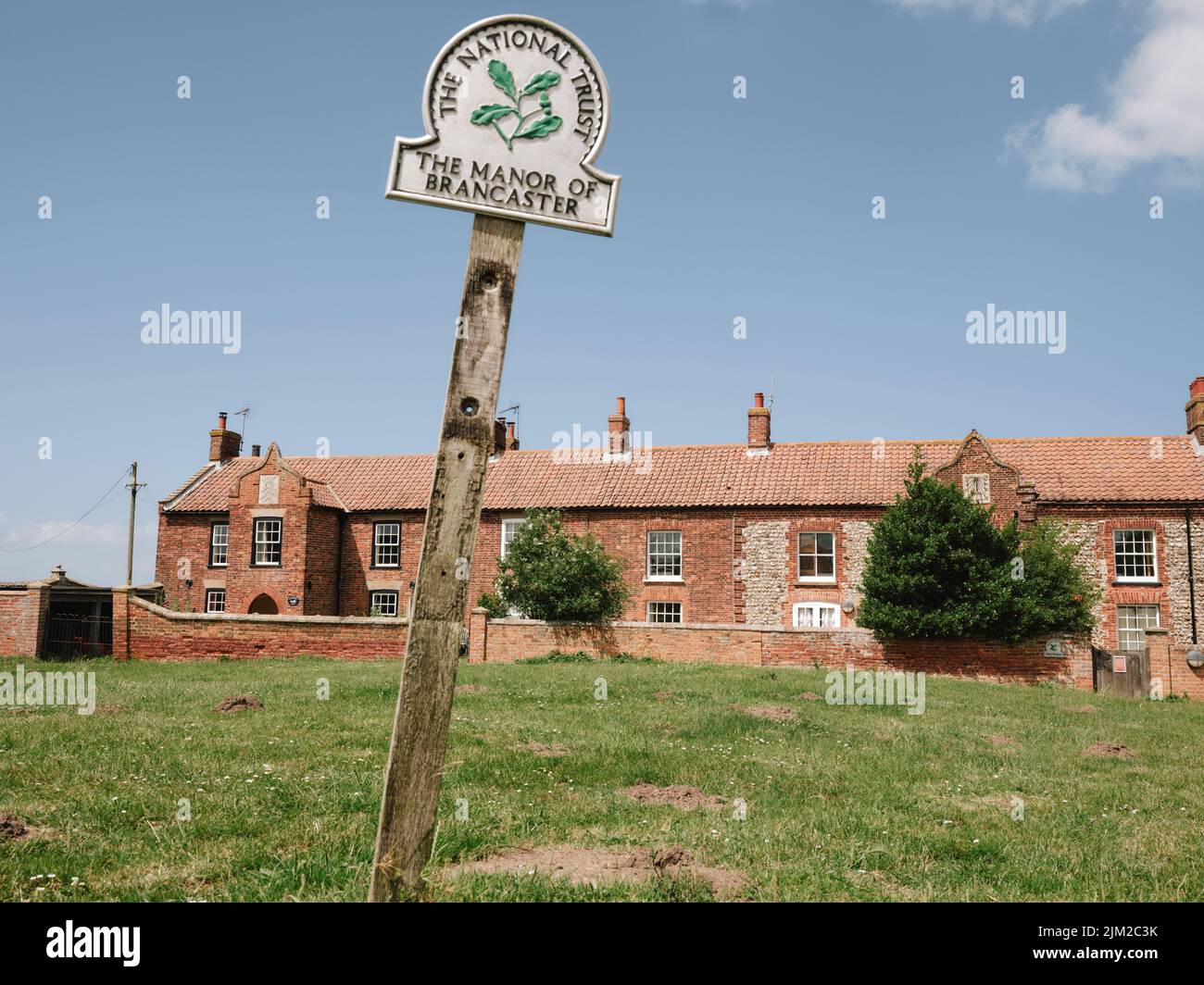 The Manor of Brancaster and National Trust sign on the green at ...
