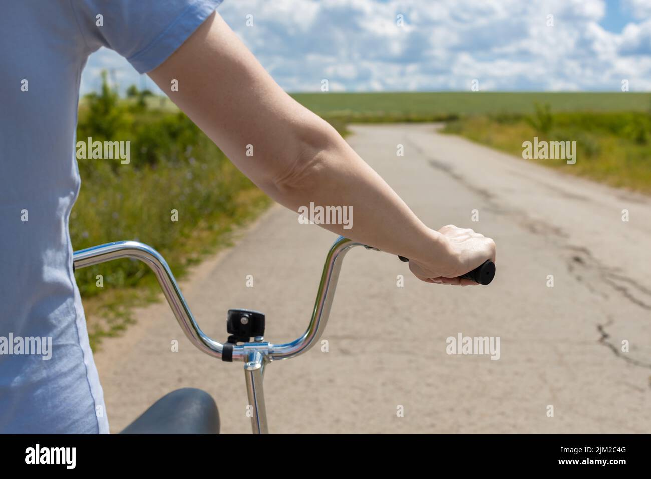 girl pushing a bike holding the steering wheel Stock Photo - Alamy