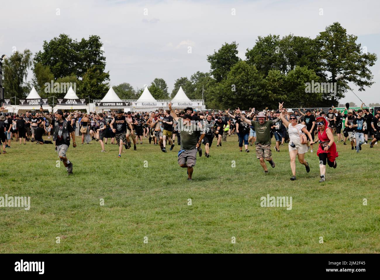 Wacken, Germany. 04th Aug, 2022. Metal fans walk across the festival ...