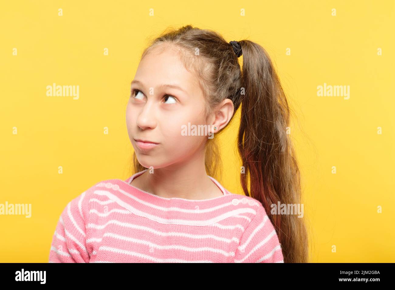 cute adolescent girl looking up sideways portrait Stock Photo - Alamy