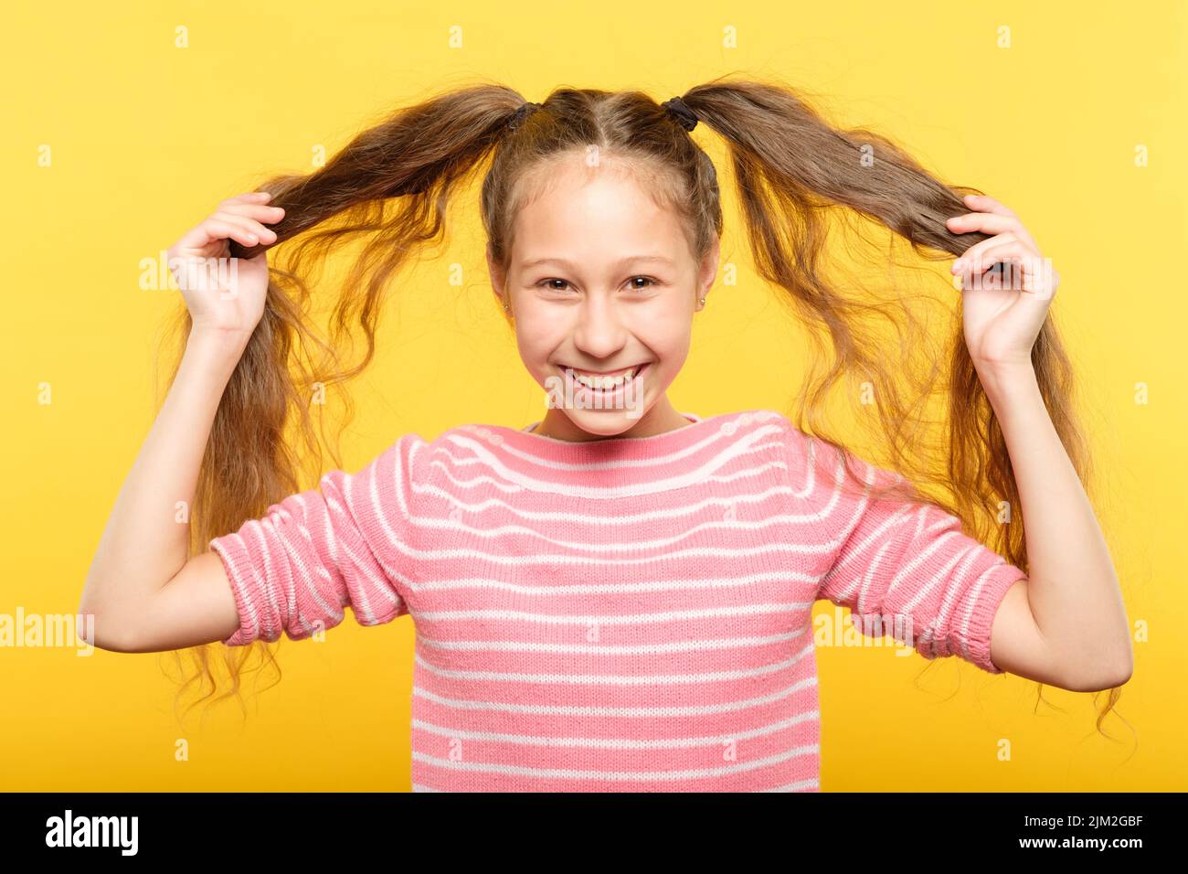 joyful adolescent girl pig tails hair childish Stock Photo - Alamy
