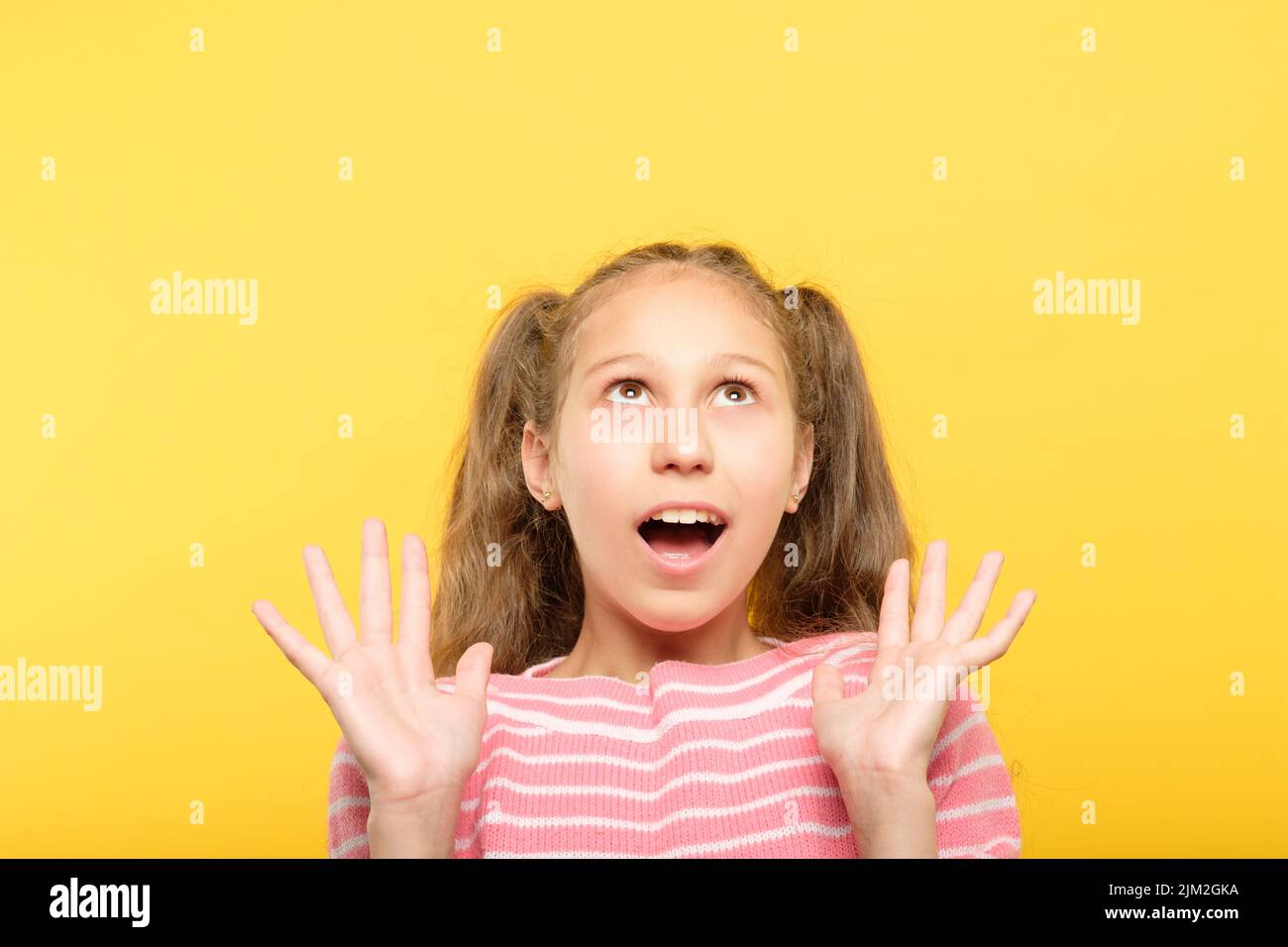 surprised shocked astonished girl look up above Stock Photo - Alamy